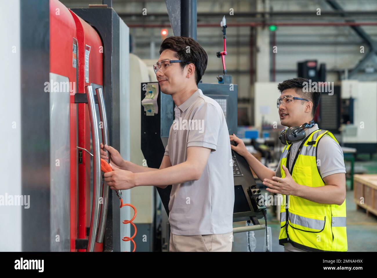 Two engineers working in the factory Stock Photo - Alamy