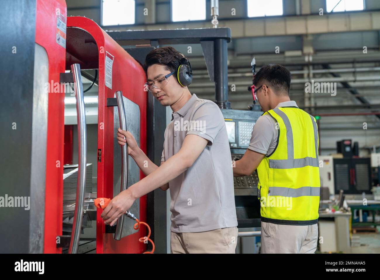 Two engineers working in the factory Stock Photo - Alamy