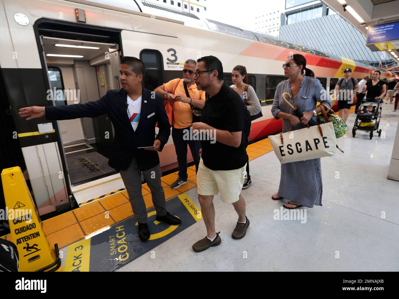Passengers board a Brightline train at MiamiCentral station for the ...