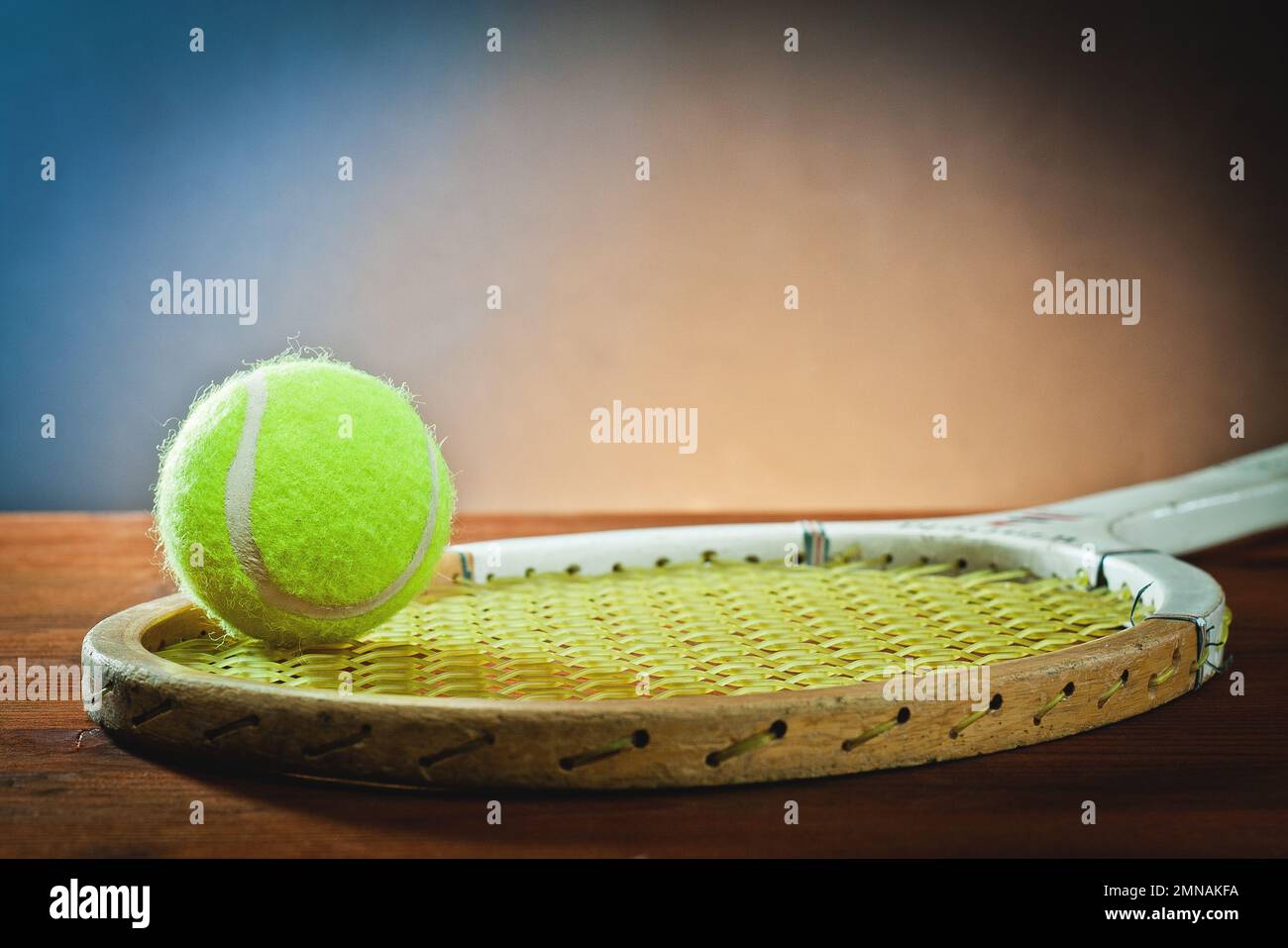 Ball and tennis racket sports equipment on wood Stock Photo - Alamy