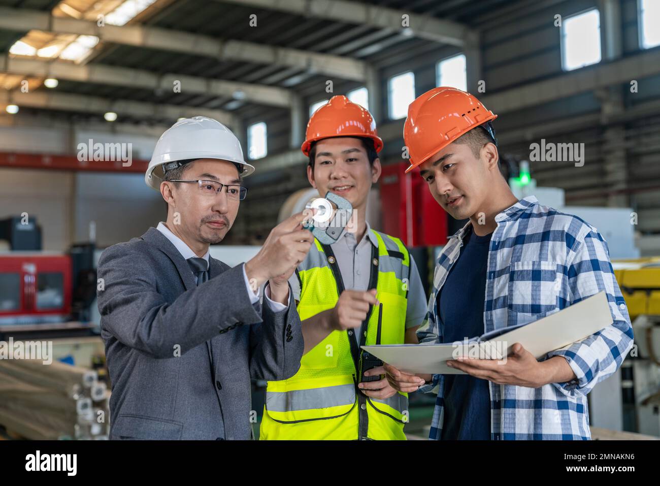 Three architects in the work Stock Photo - Alamy