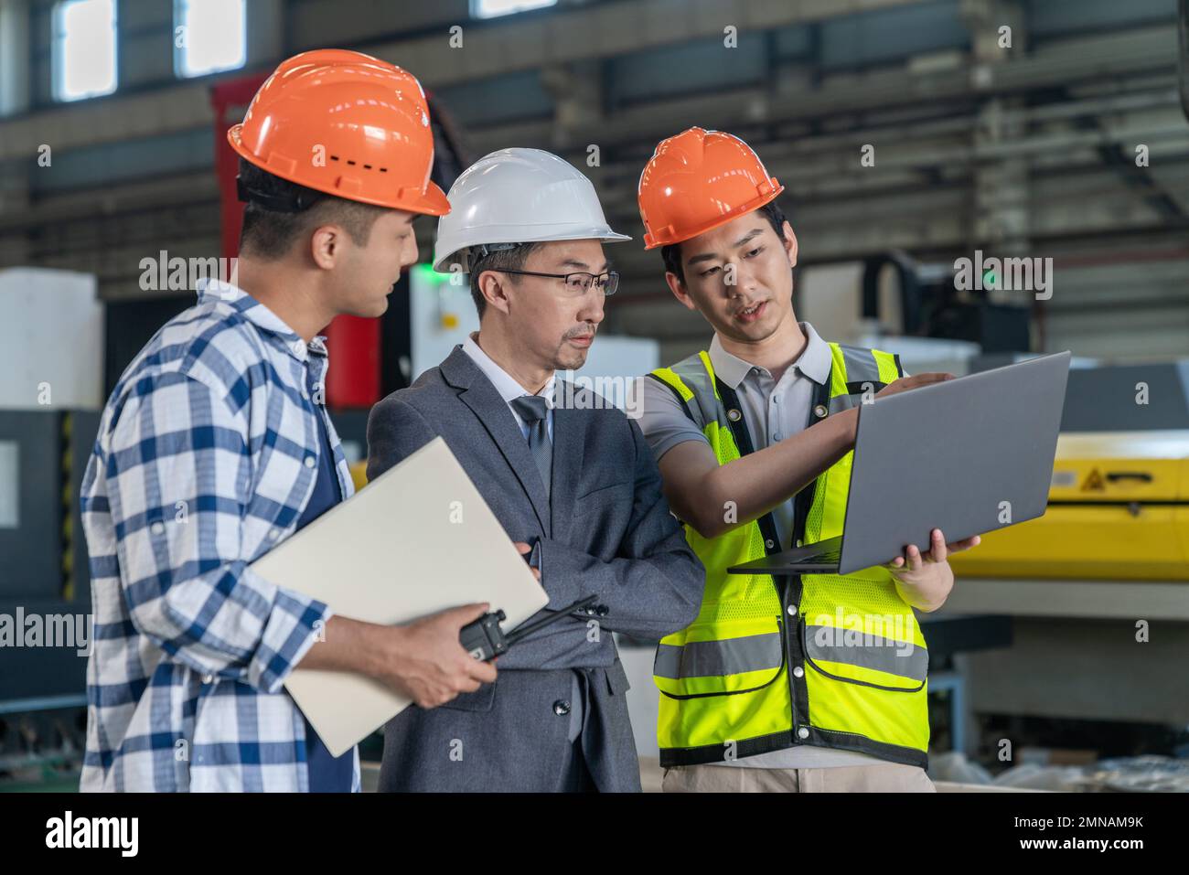 Three architects in the work Stock Photo - Alamy