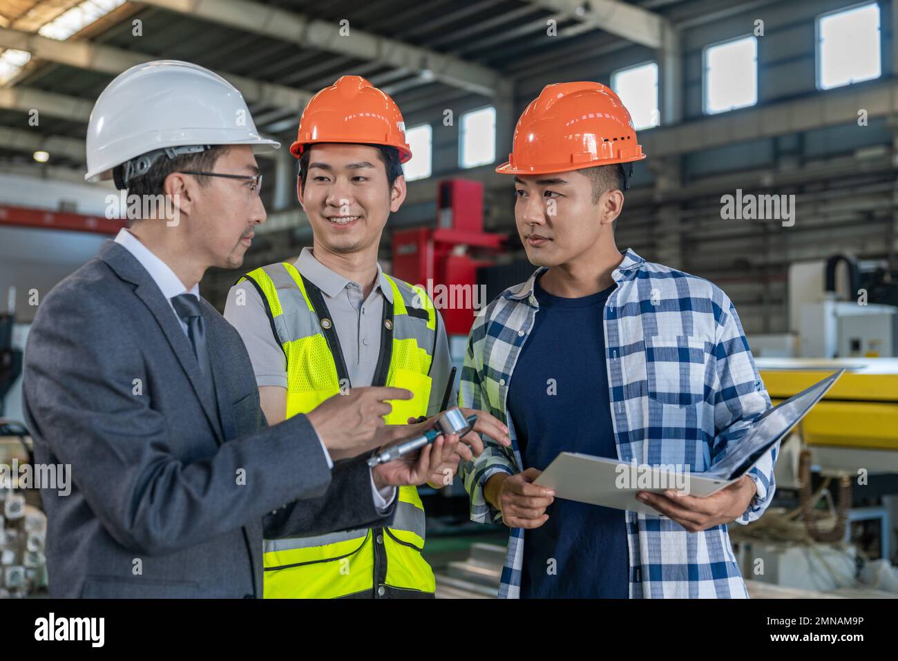 Three architects in the work Stock Photo - Alamy