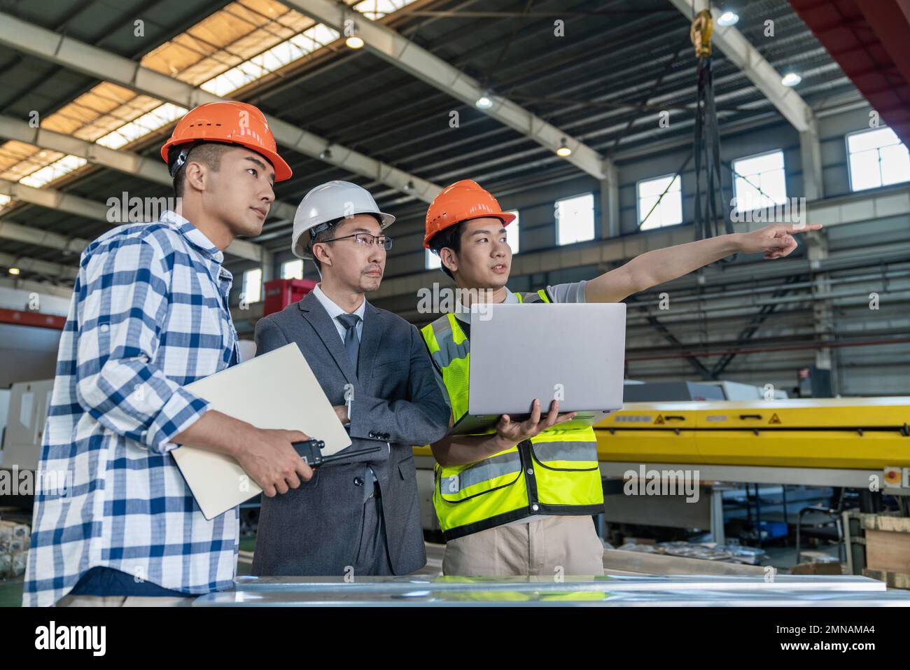 Three architects in the work Stock Photo - Alamy