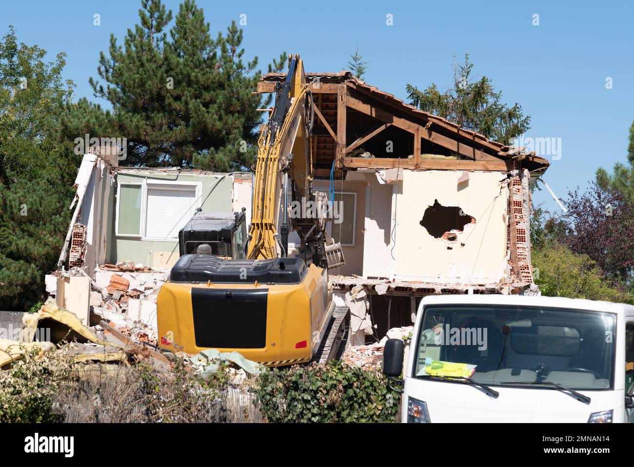 house demolition demolishing building with a large backhoe Stock Photo ...