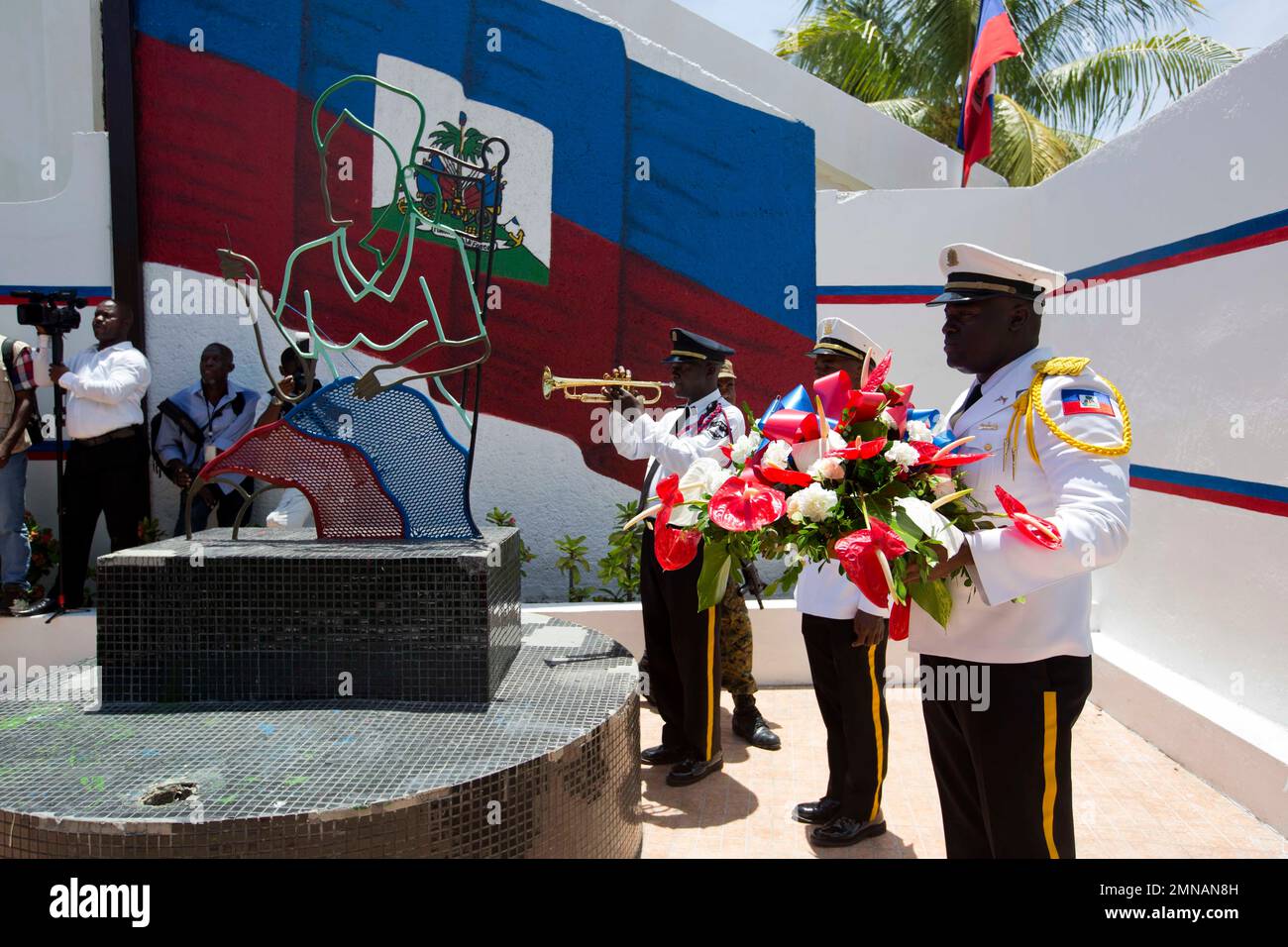 National police officers hold flowers as they wait for Haiti's ...