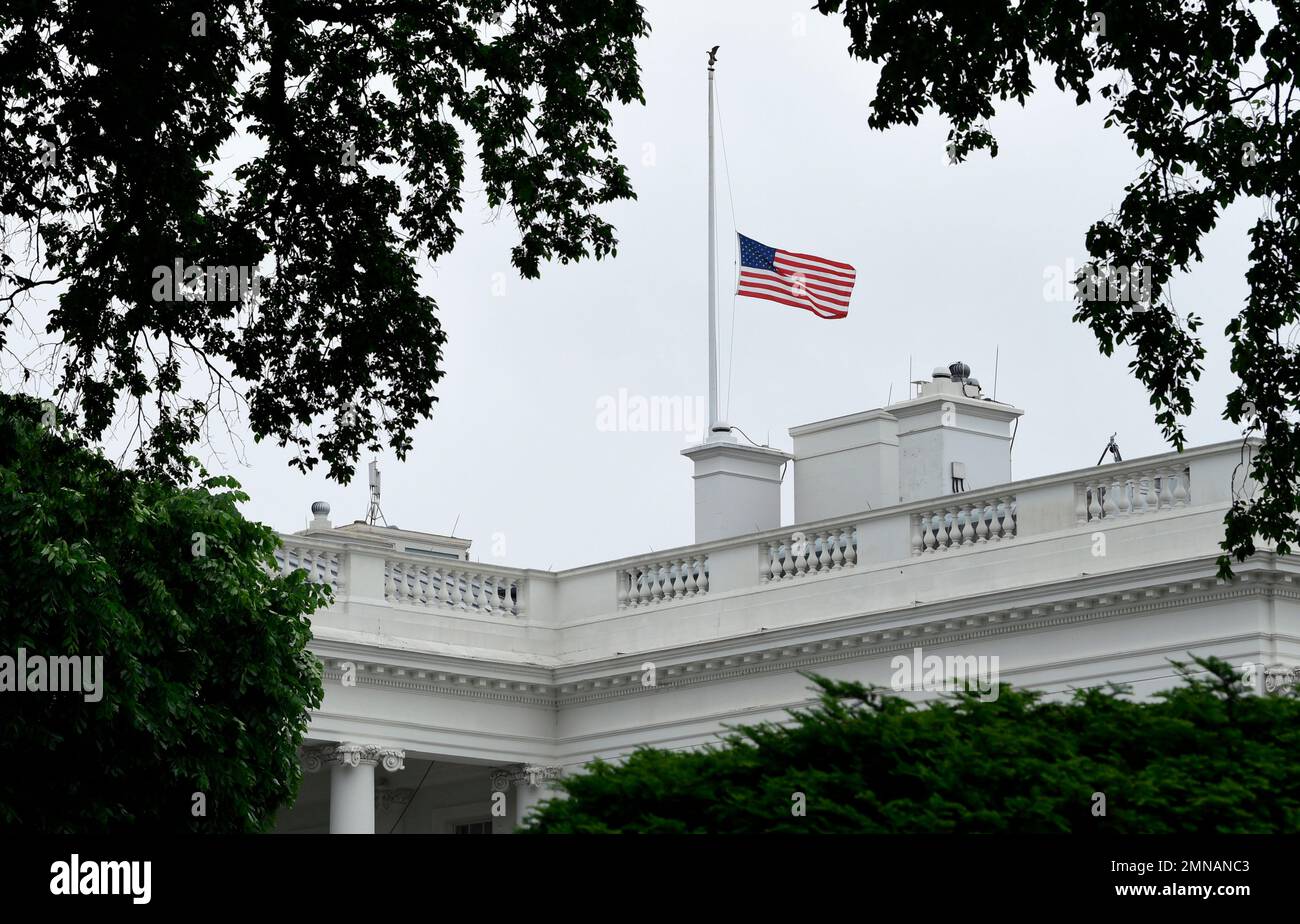 The American flag is lowered to half-staff at the White House in ...
