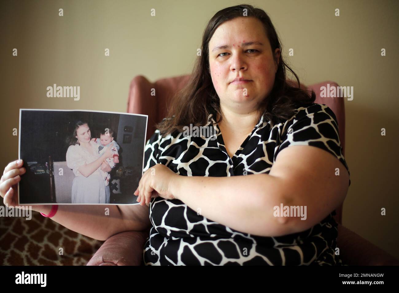 Heidi Clark holds a photograph showing her daughter at her home in Orem ...