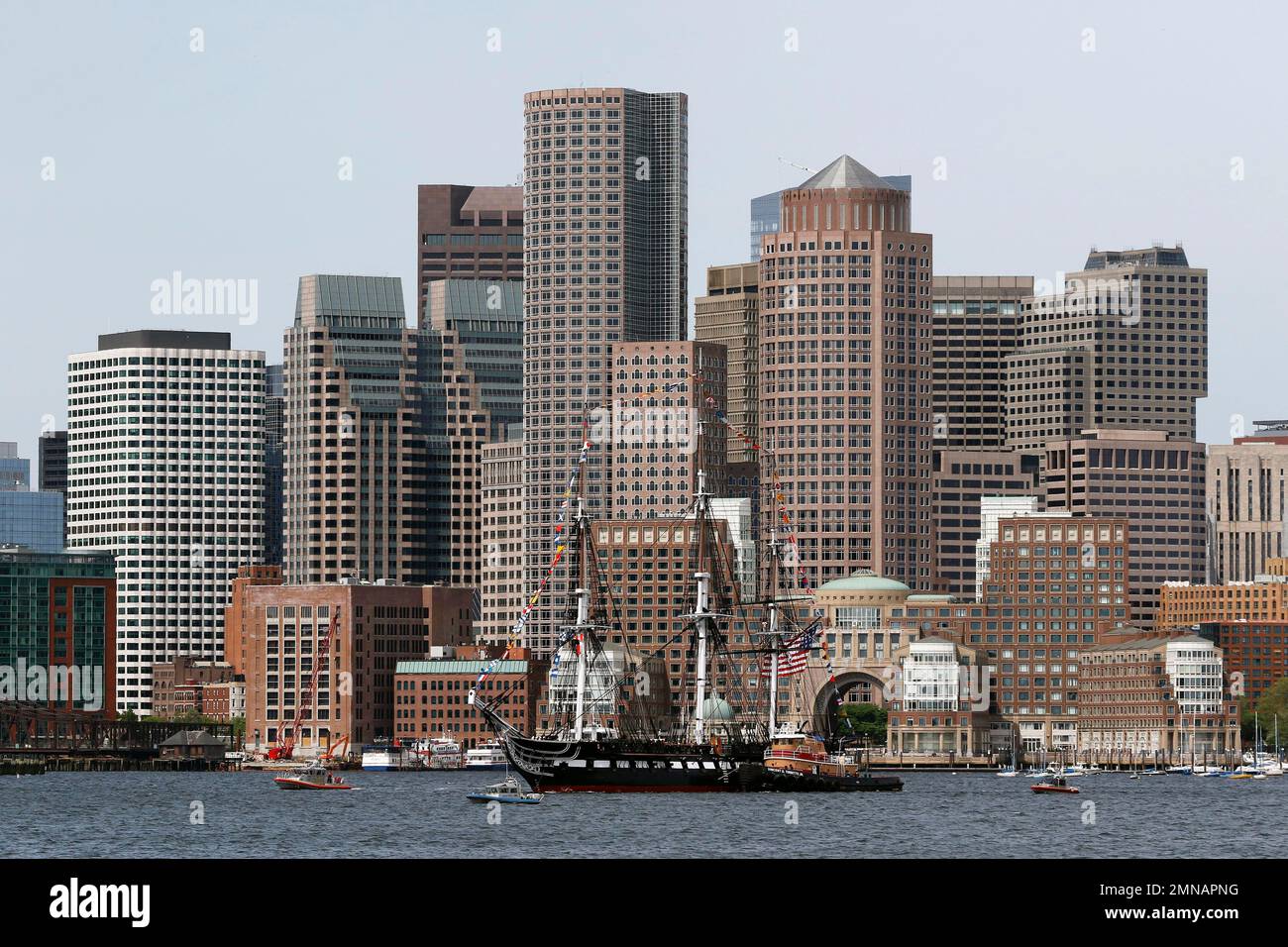 The USS Constitution glides through Boston Harbor past the city skyline ...