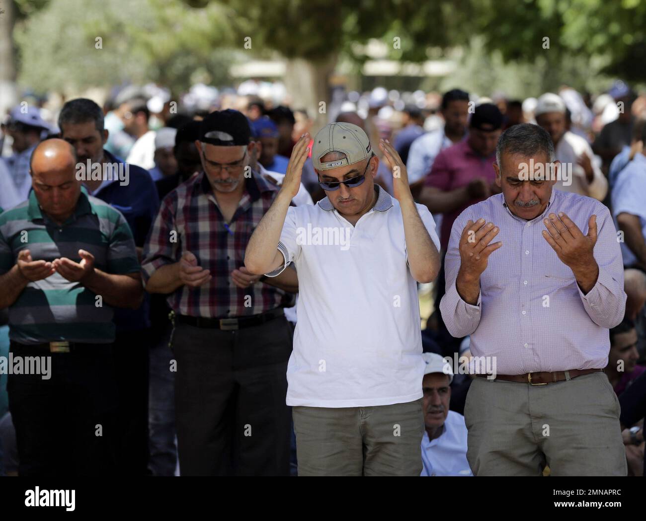 Palestinians pray in front at al-Aqsa mosque compound during the first ...