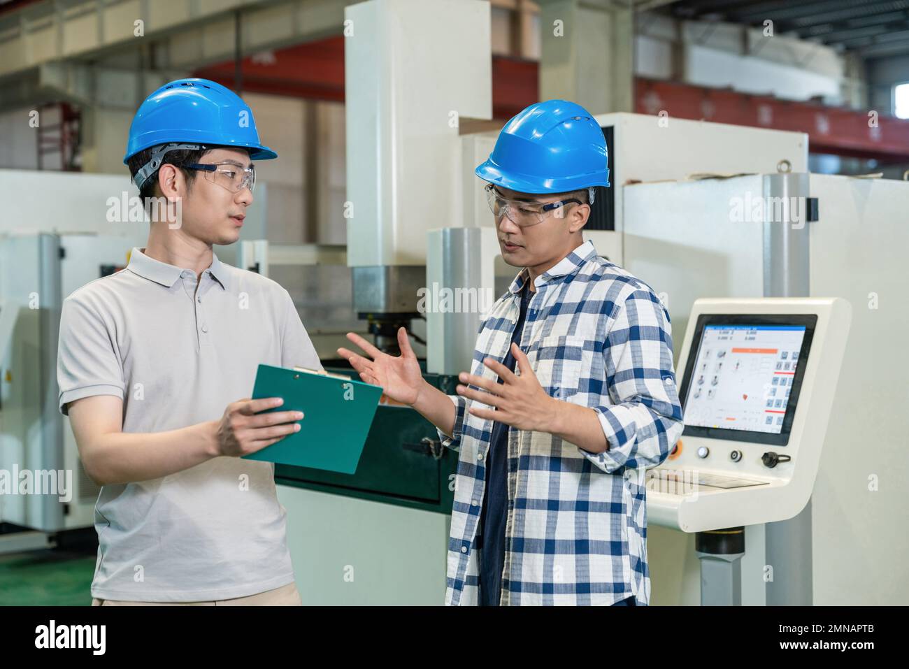 Two engineers working in the factory Stock Photo - Alamy