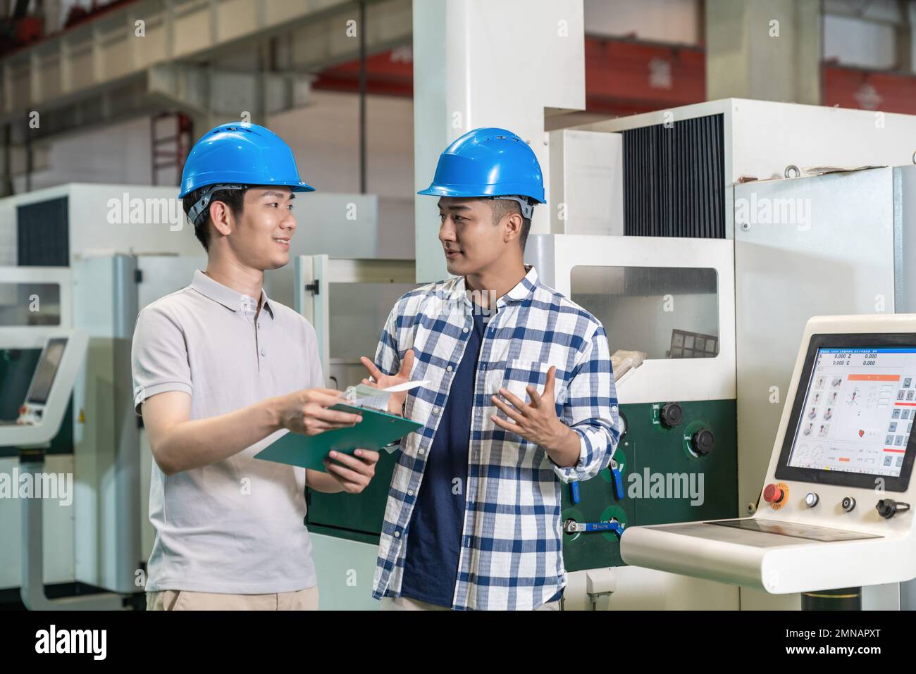 Two engineers working in the factory Stock Photo - Alamy