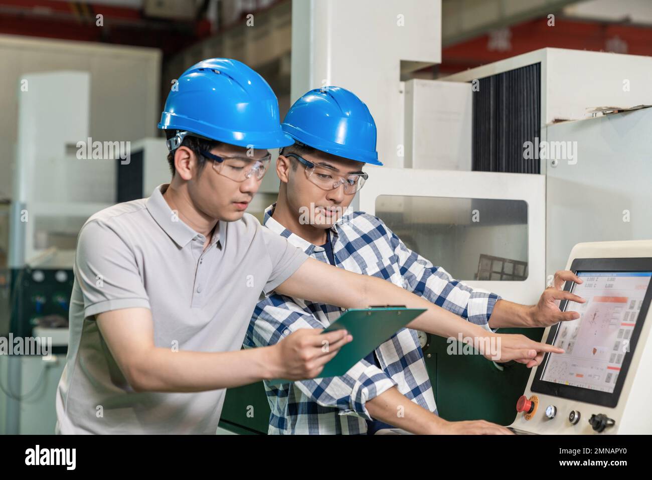 Two engineers working in the factory Stock Photo - Alamy
