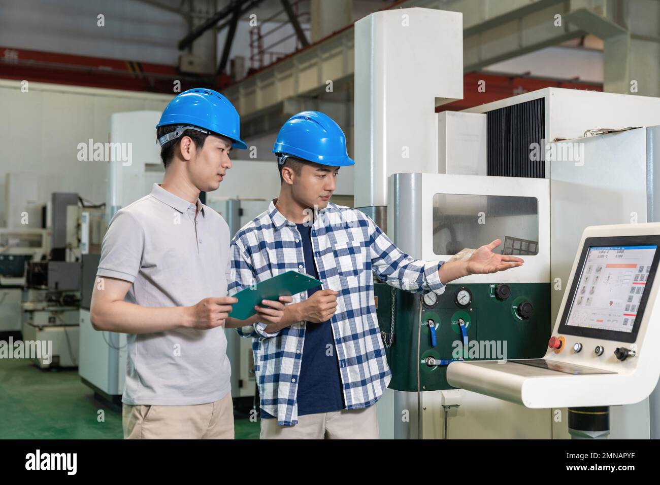 Two engineers working in the factory Stock Photo - Alamy