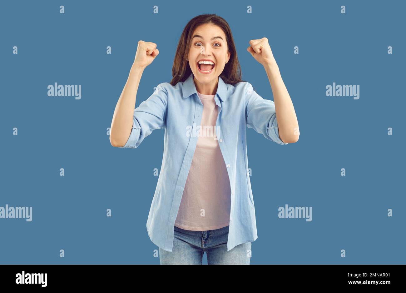 Yes. Happy, pretty, smiling, young woman in white T-shirt and blue ...