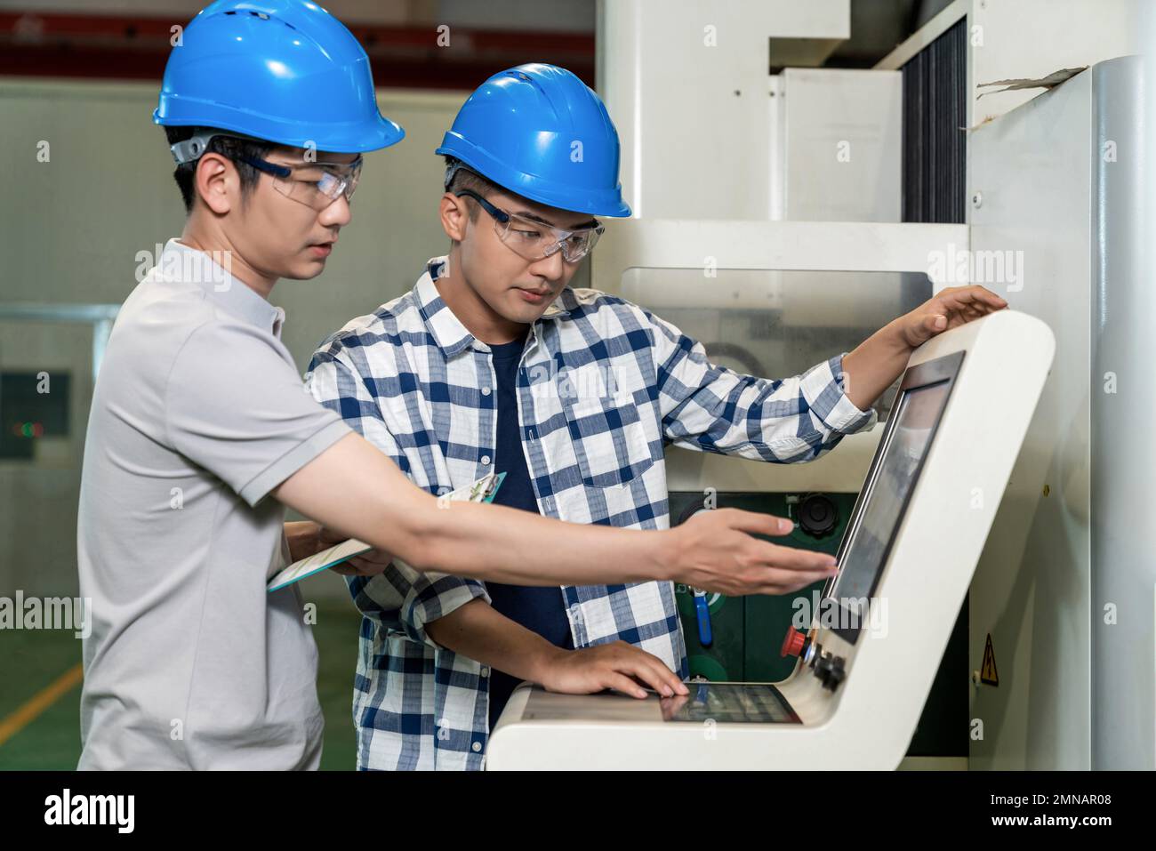 Two engineers working in the factory Stock Photo - Alamy