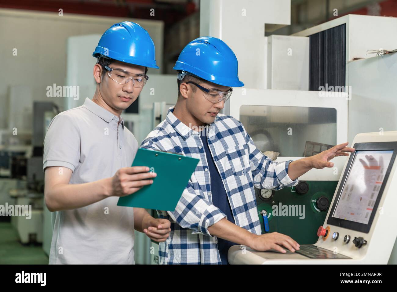 Two engineers working in the factory Stock Photo - Alamy