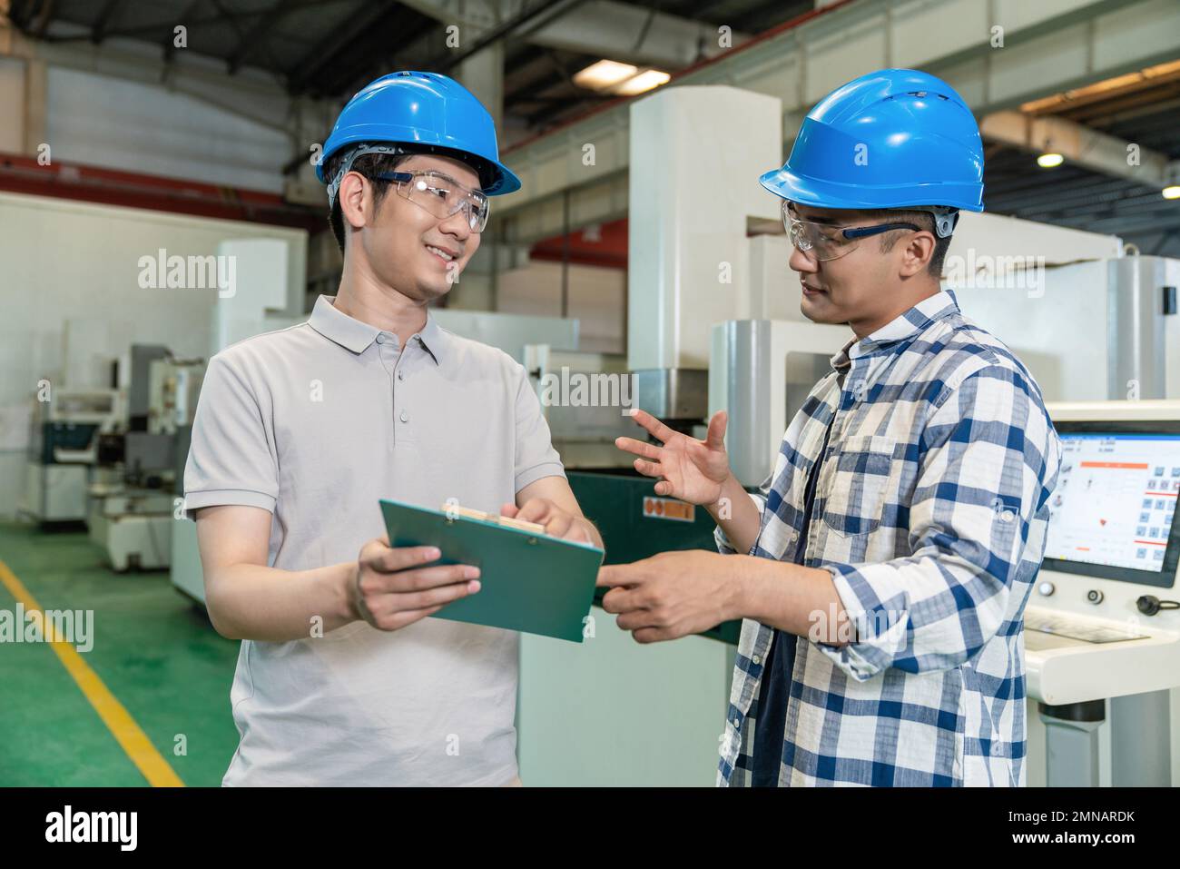 Two engineers working in the factory Stock Photo - Alamy