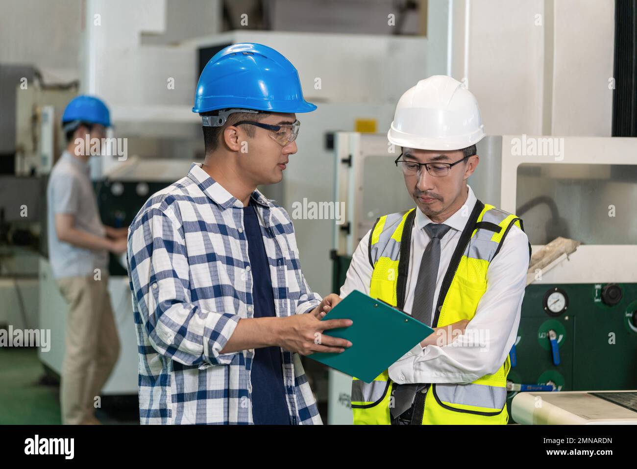 Two engineers working in the factory Stock Photo - Alamy