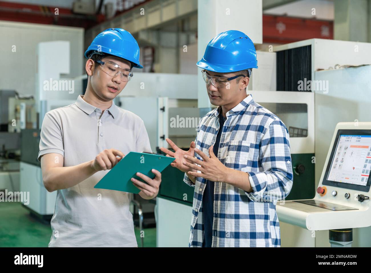 Two engineers working in the factory Stock Photo - Alamy