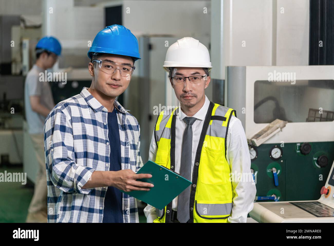 Two engineers working in the factory Stock Photo - Alamy
