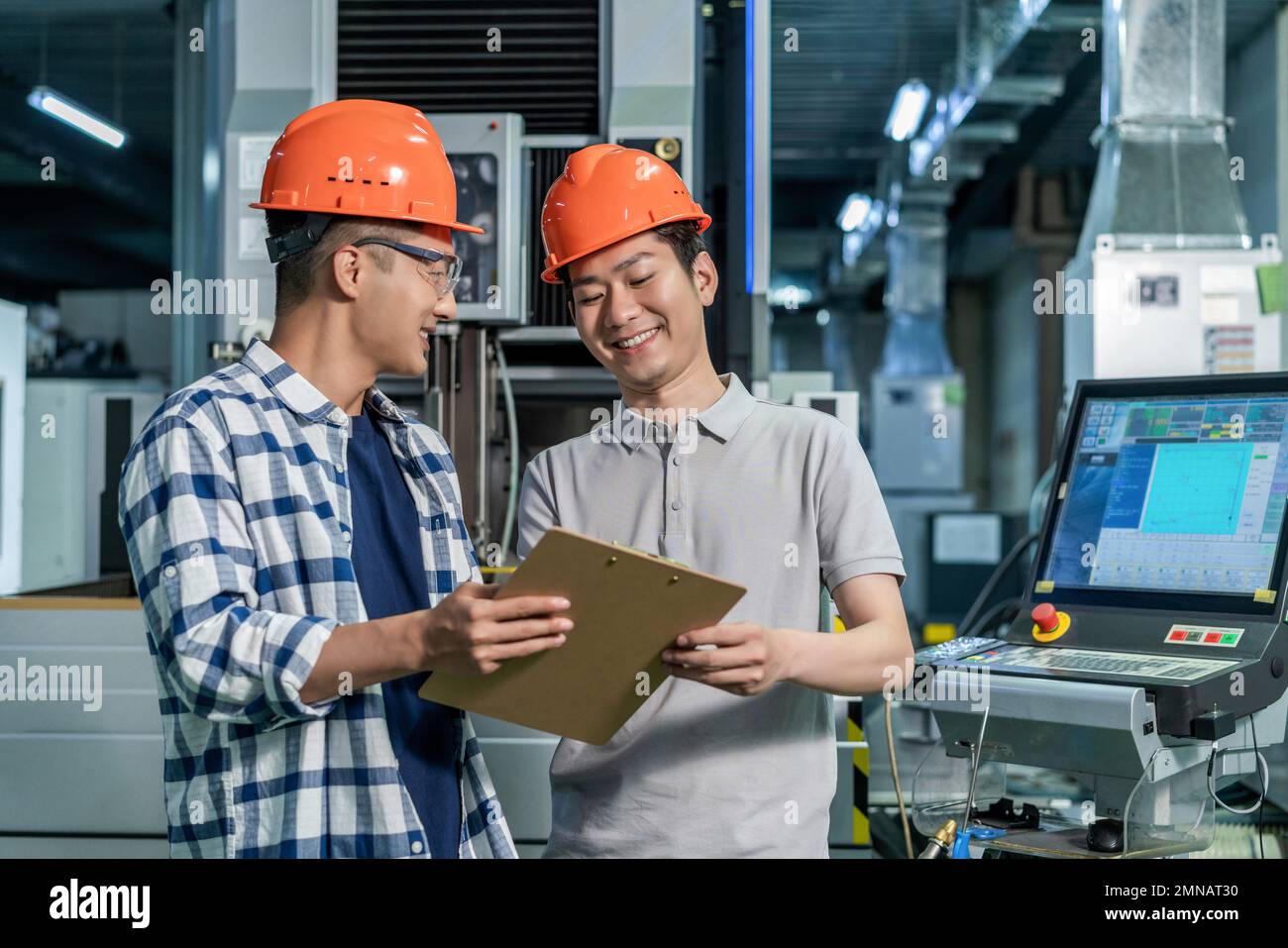Two engineers working in the factory Stock Photo - Alamy