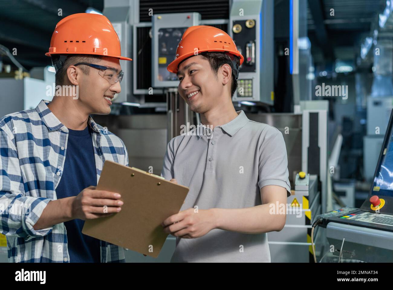 Two engineers working in the factory Stock Photo - Alamy