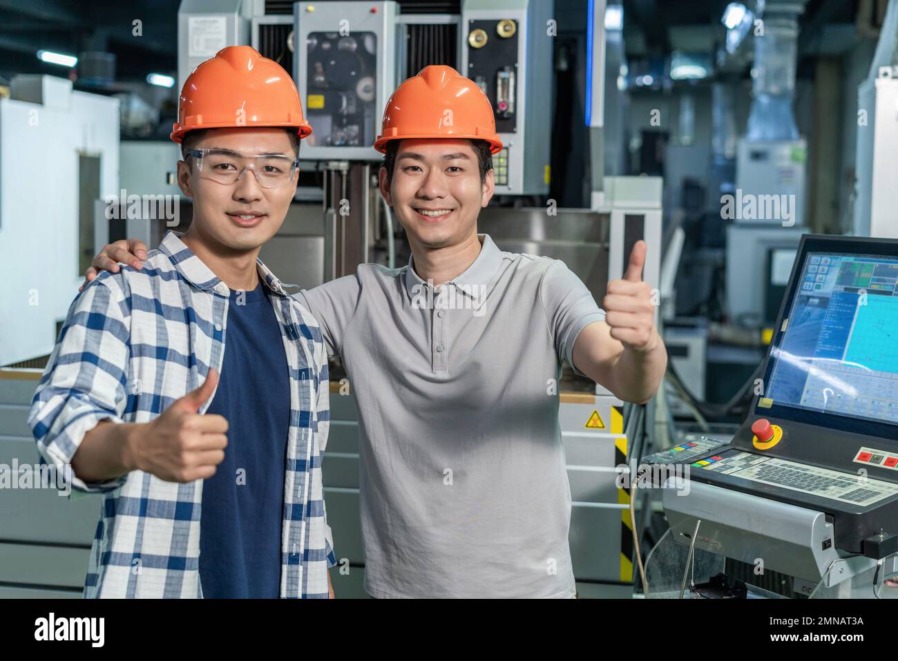 Two engineers working in the factory Stock Photo - Alamy