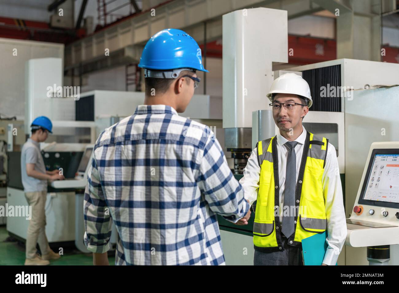 Two engineers working in the factory Stock Photo - Alamy