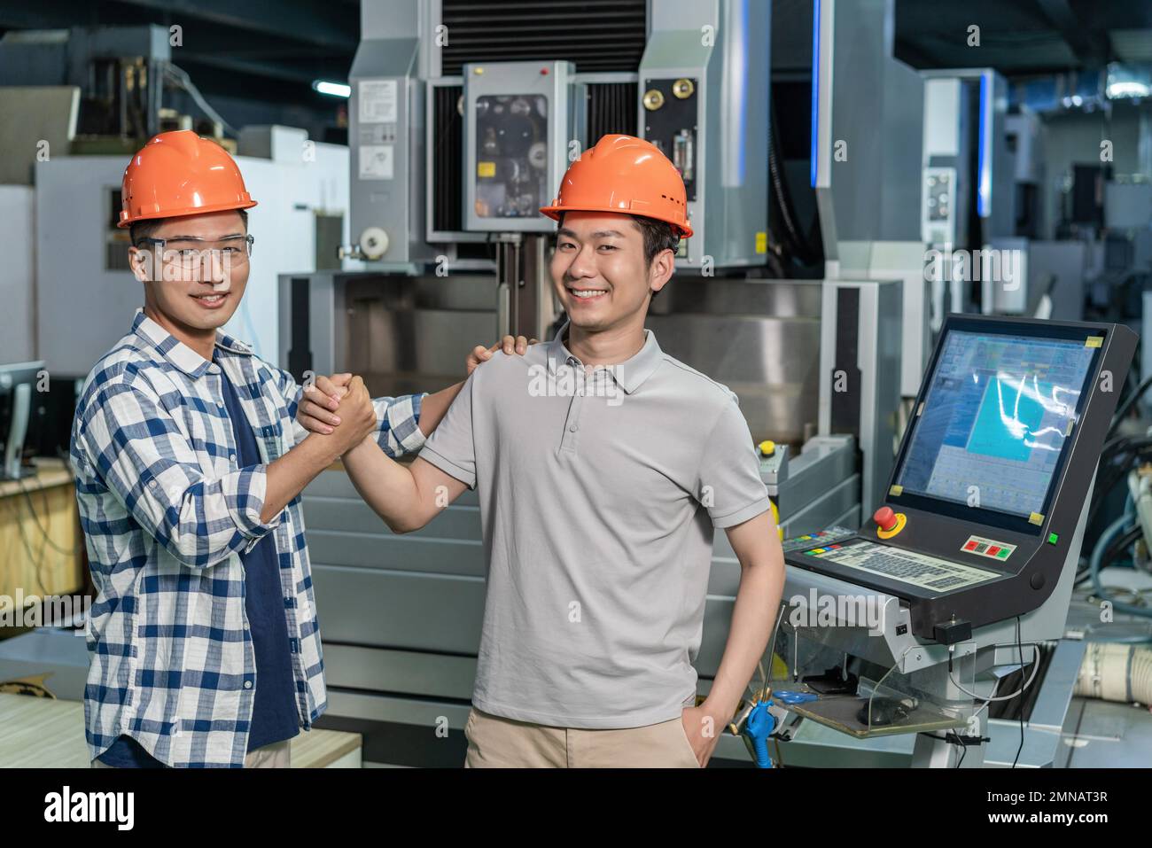 Two engineers working in the factory Stock Photo - Alamy