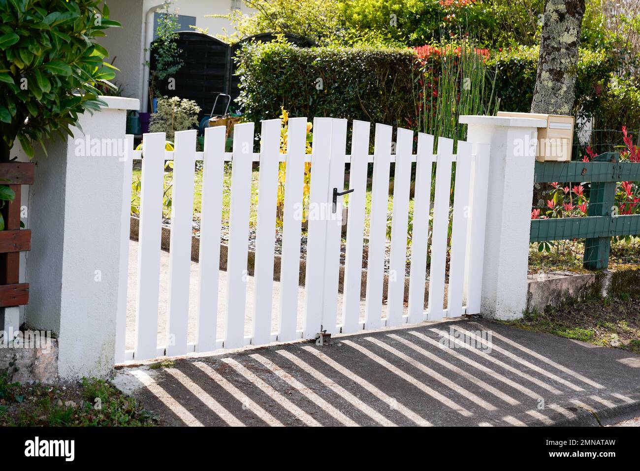 metal steel gate white home on suburb street house Stock Photo - Alamy