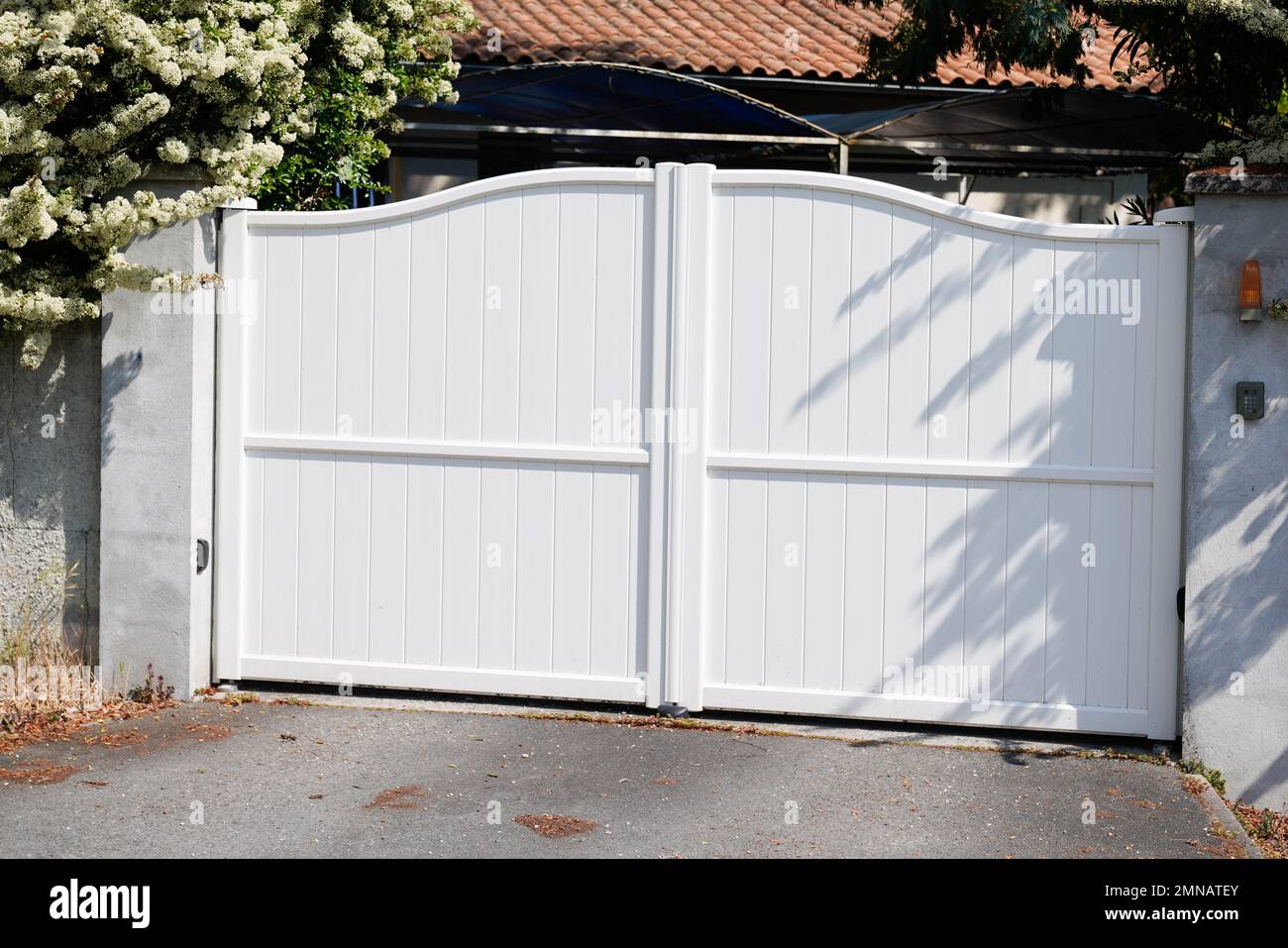 suburb portal home white high house gate slats gate Stock Photo - Alamy