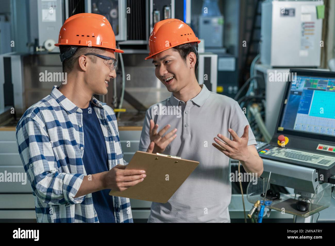 Two engineers working in the factory Stock Photo - Alamy