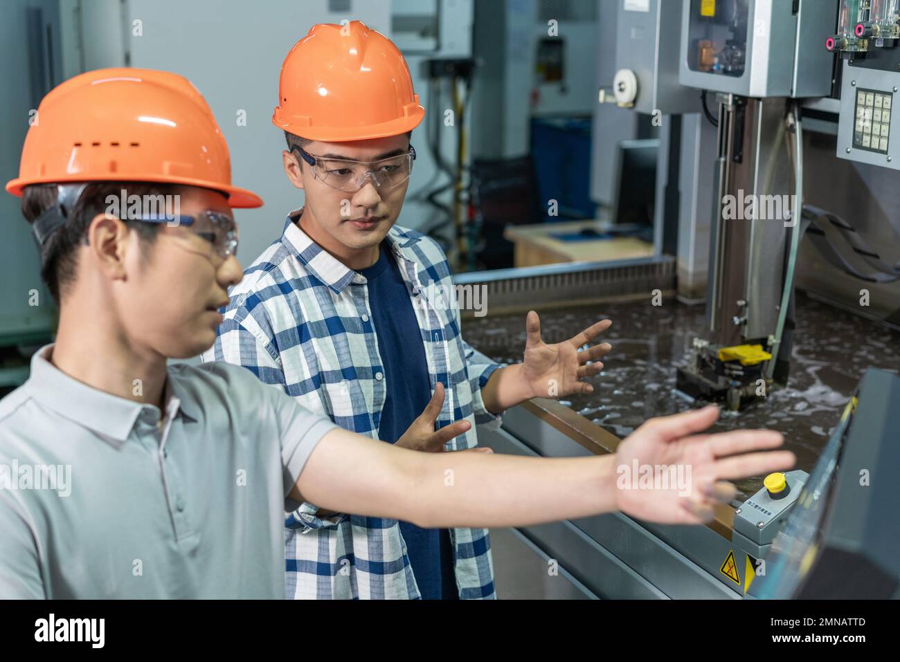 Two engineers working in the factory Stock Photo - Alamy