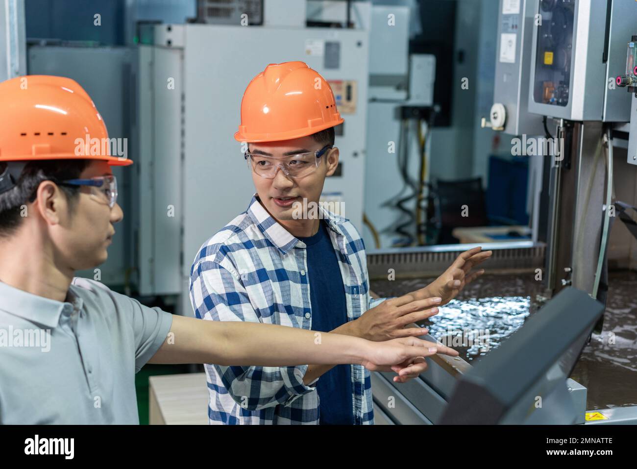 Two engineers working in the factory Stock Photo - Alamy