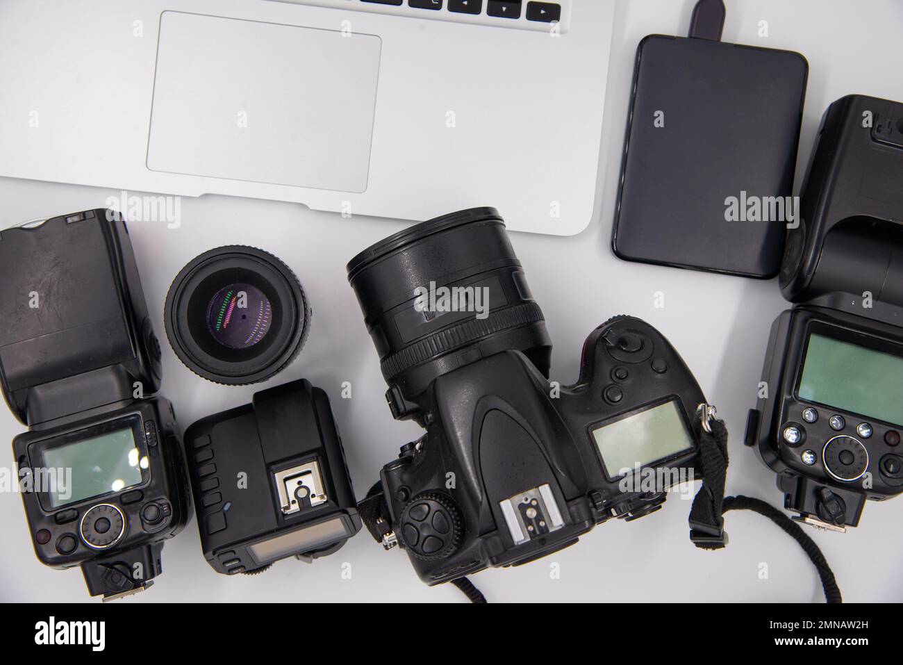 top view of work space photographer with digital camera, flash ...