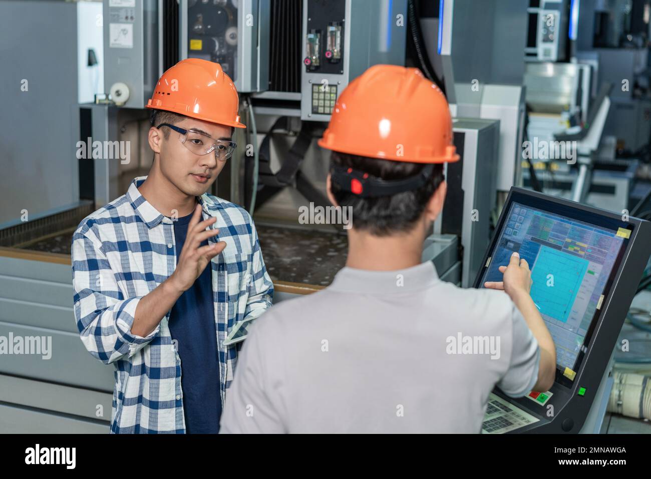 Two engineers working in the factory Stock Photo - Alamy