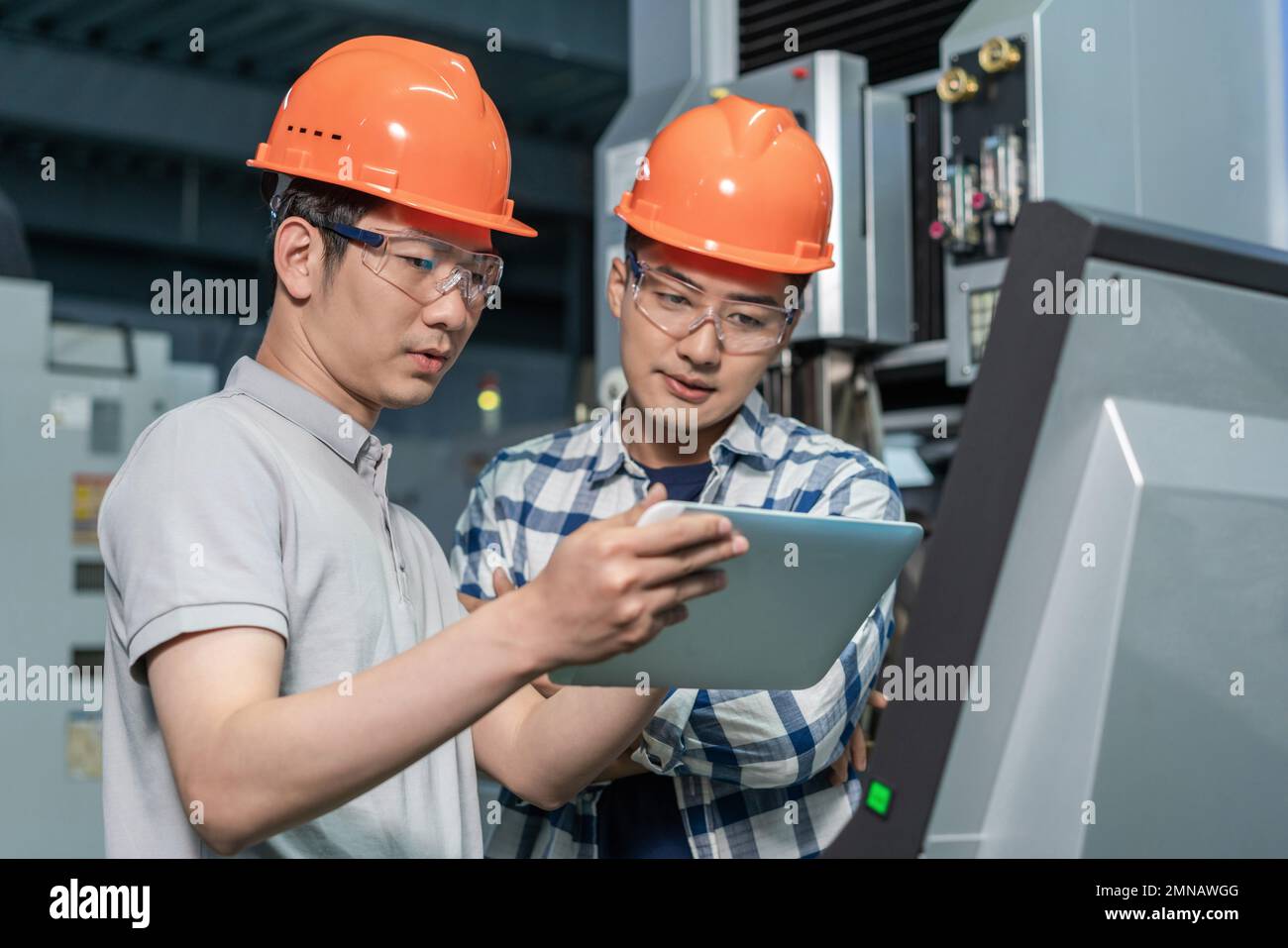 Two engineers working in the factory Stock Photo - Alamy