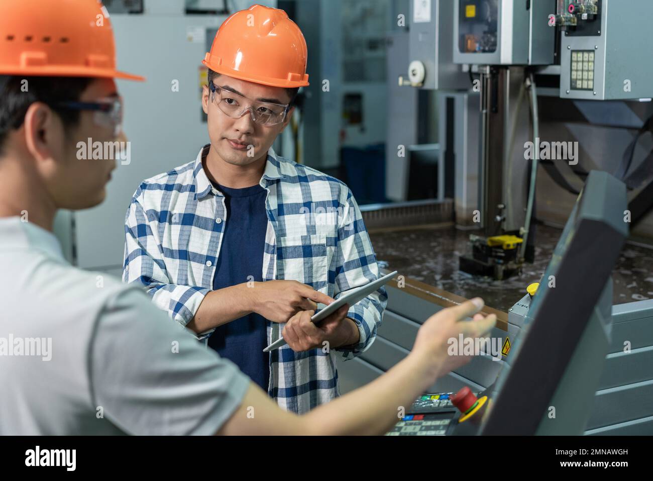 Two engineers working in the factory Stock Photo - Alamy