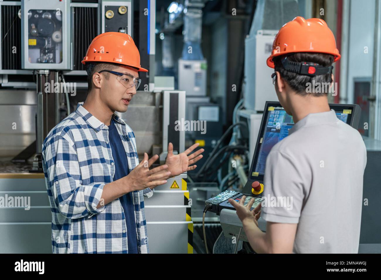 Two engineers working in the factory Stock Photo - Alamy