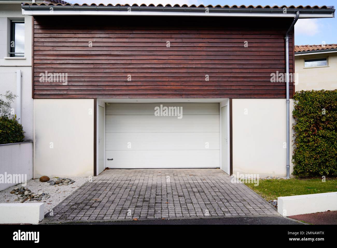 closed shutter door roller white metal garage gate in home facade wall ...