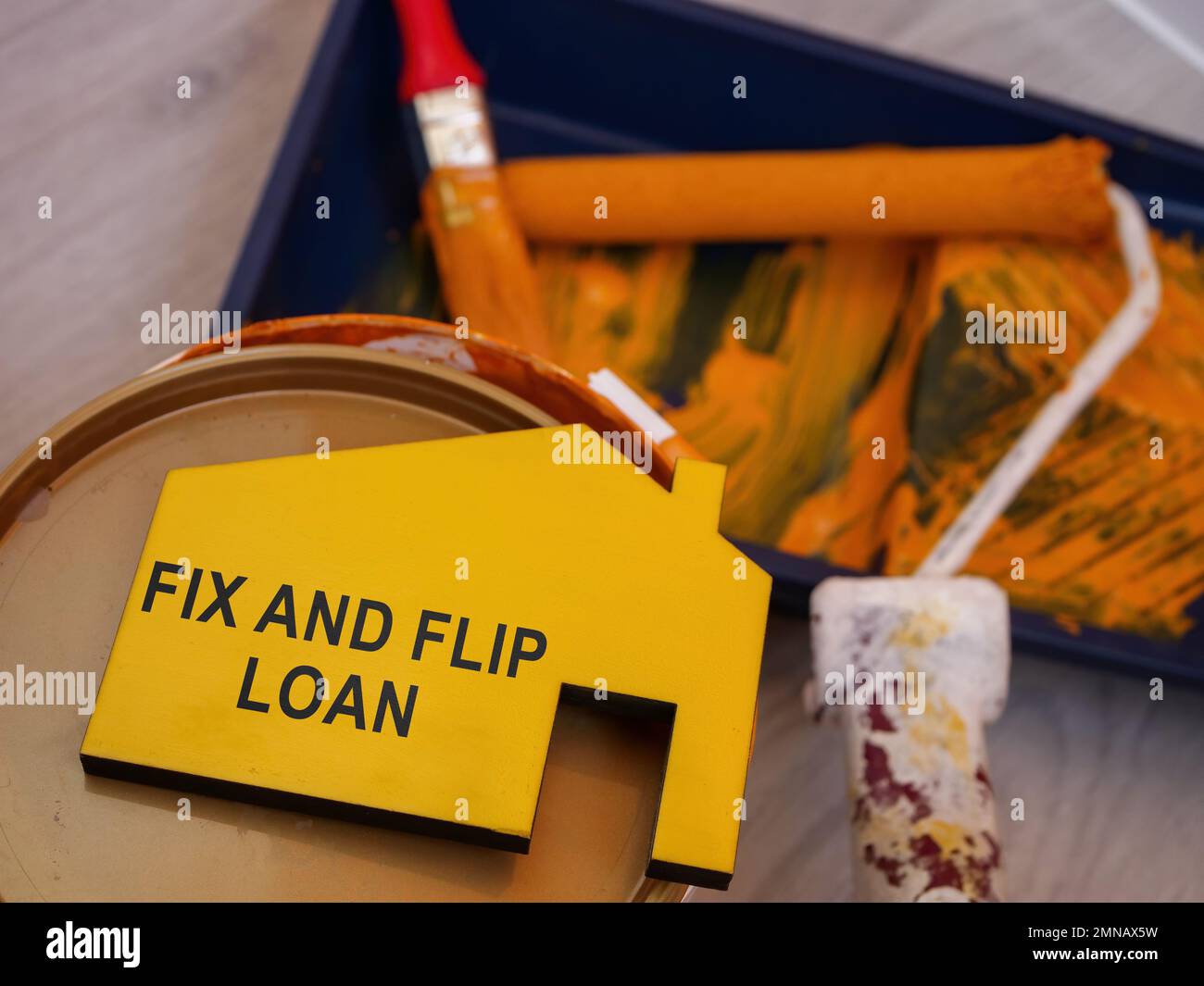 Fix and flip loan inscription, can of paint and brush Stock Photo - Alamy