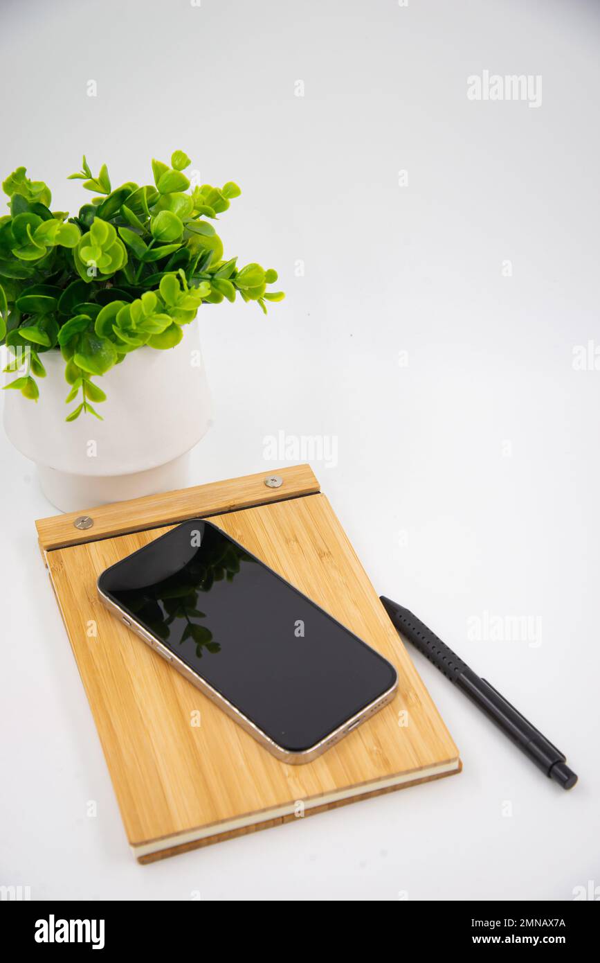 Mobile smart phone with blank screen of gadget on notebook. Digital ...