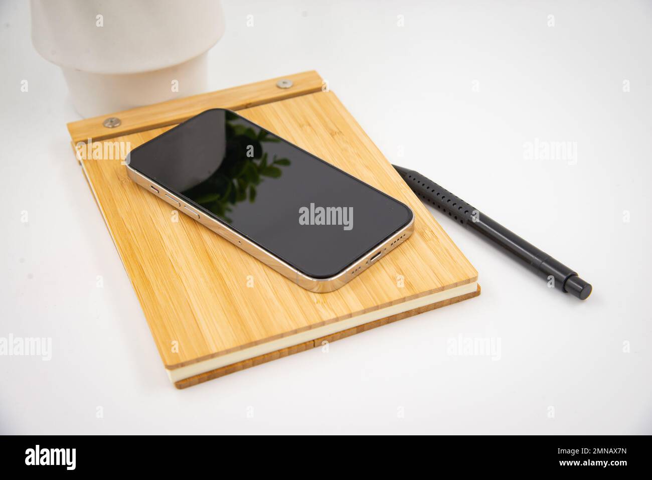 Mobile smart phone with blank screen of gadget on notebook. Digital ...