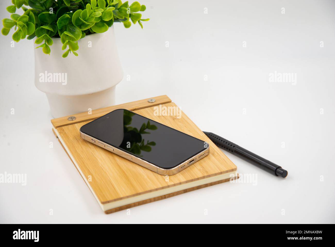 Mobile smart phone with blank screen of gadget on notebook. Digital ...