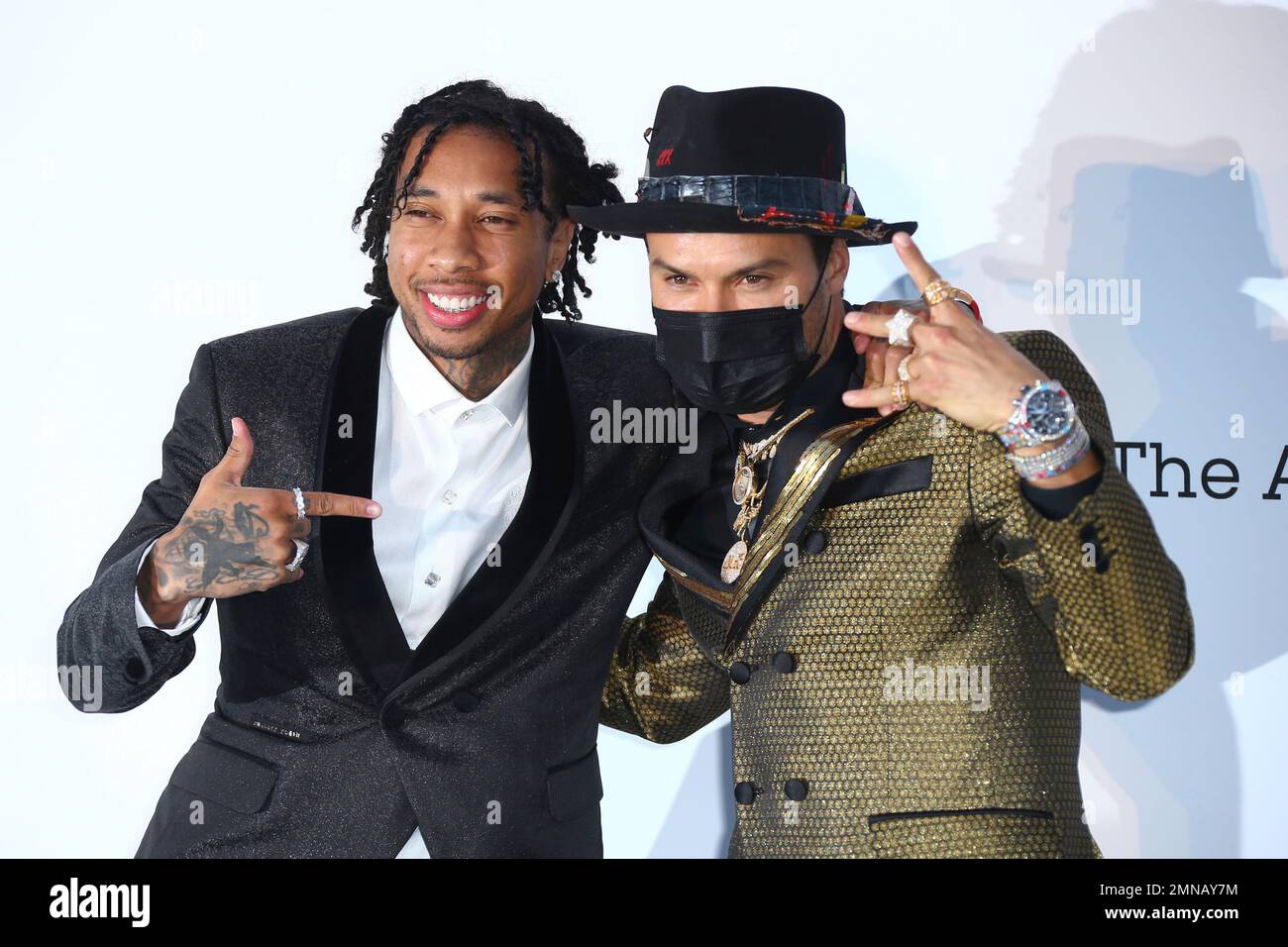 Rapper Tyga, left, and artist Alec Monopoly pose for photographers upon ...