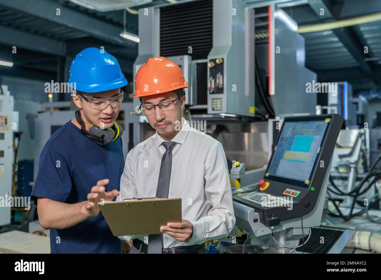 Two engineers working in the factory Stock Photo - Alamy
