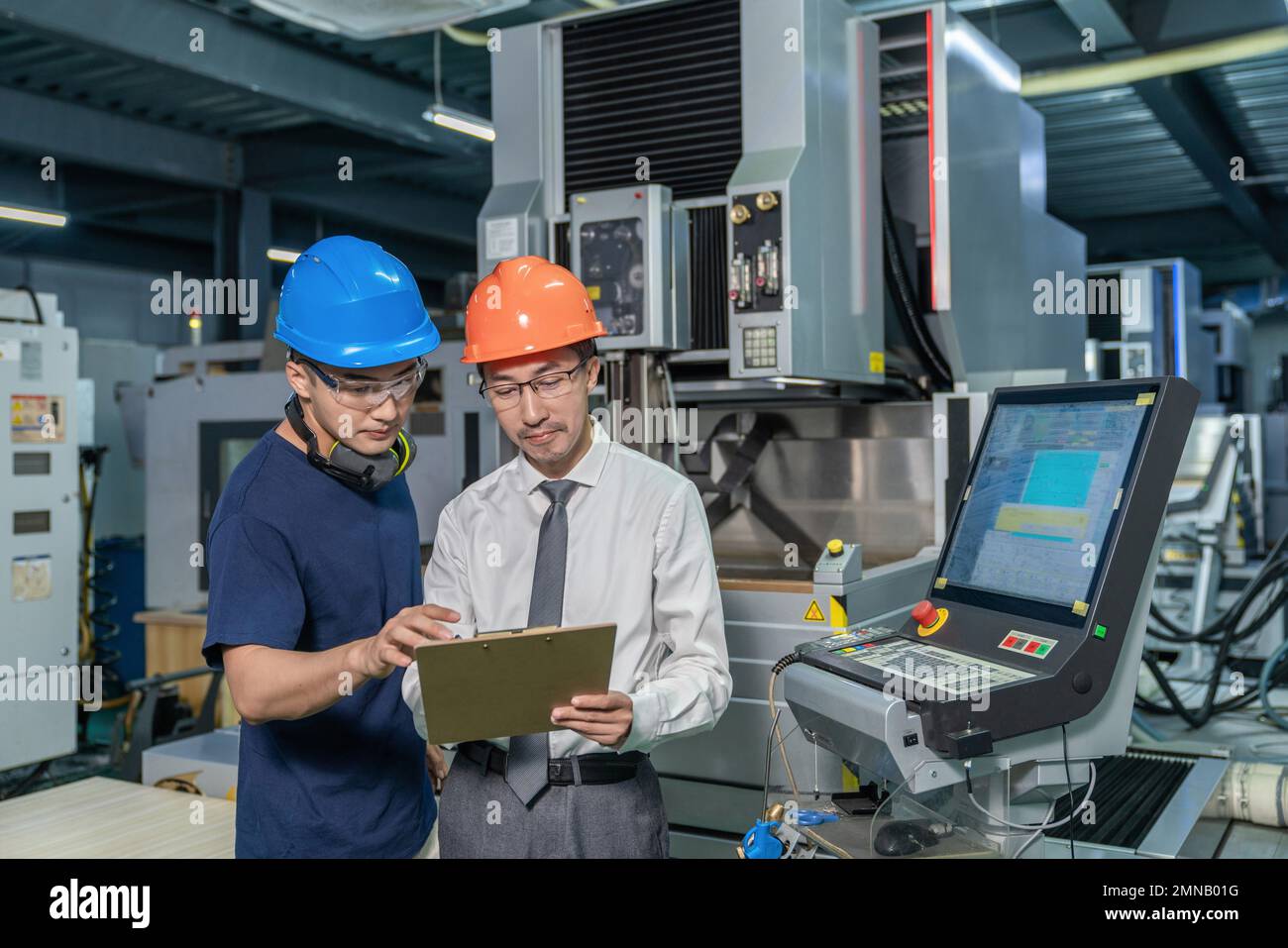 Two engineers working in the factory Stock Photo - Alamy