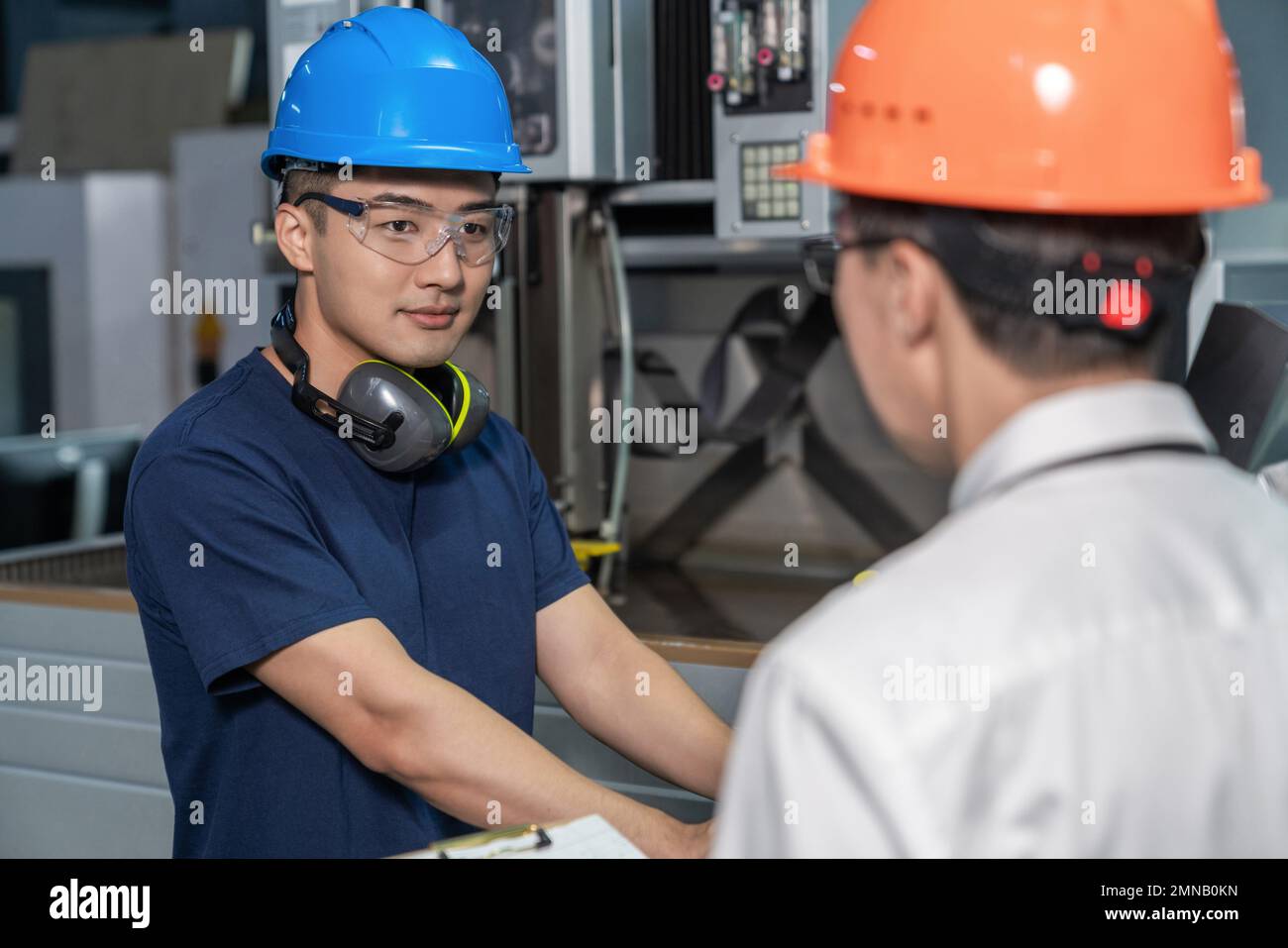 Two engineers working in the factory Stock Photo - Alamy