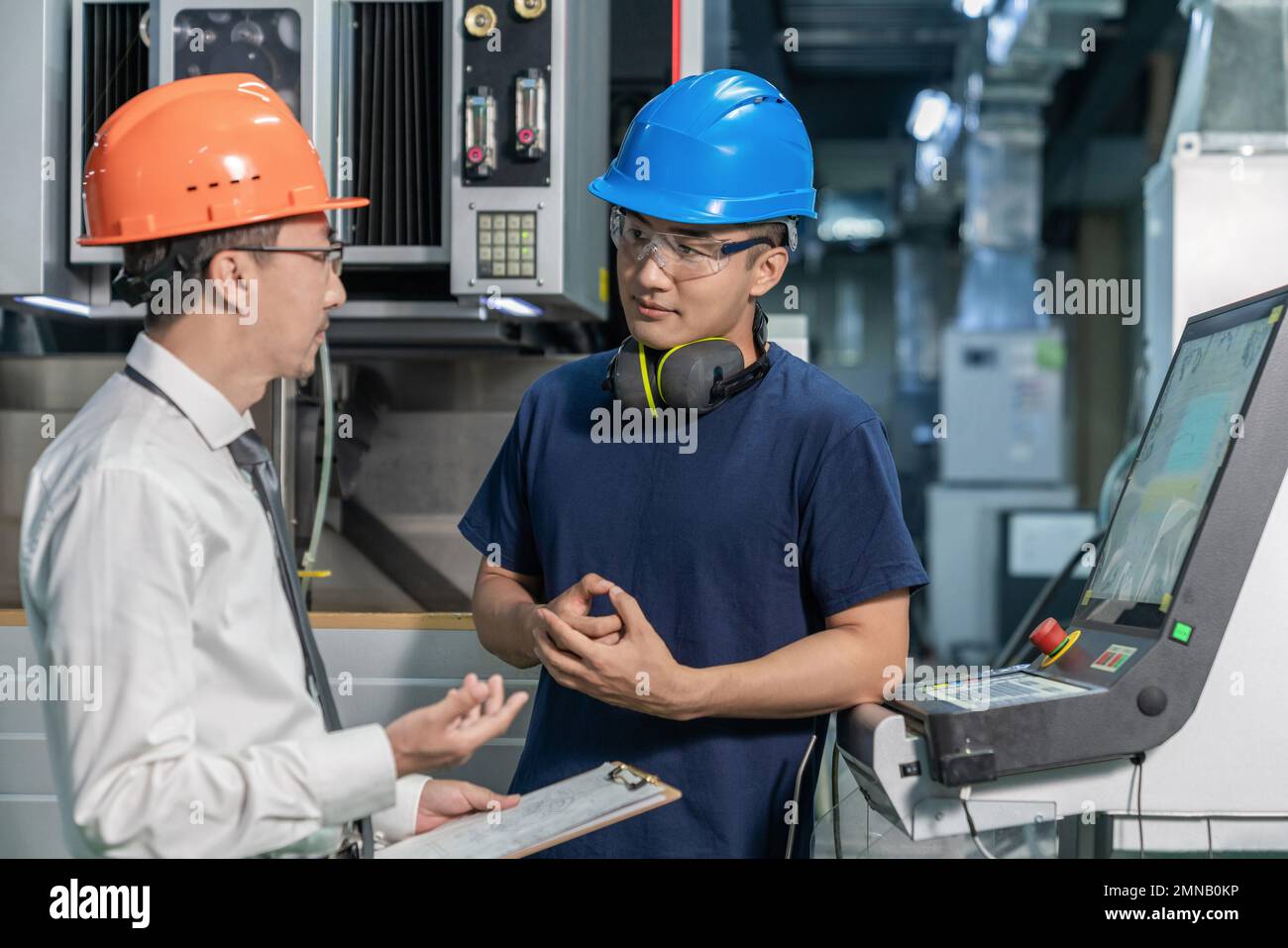 Two engineers working in the factory Stock Photo - Alamy